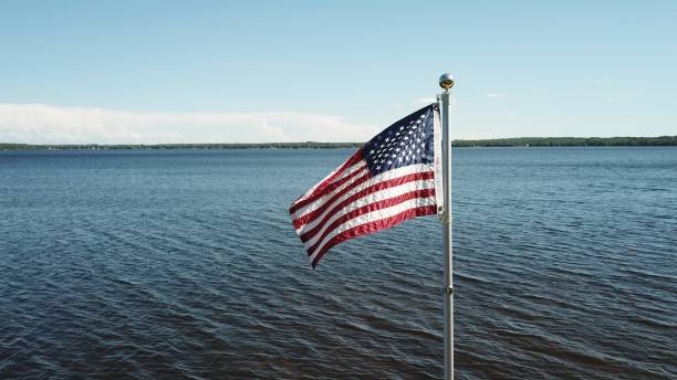 Free Stock Photo of American Flag Flying Over Body of Water | Download ...