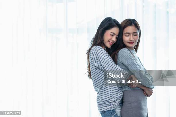 Two Asian Lesbian Women Hug And Embracing Together In Bedroom Couple