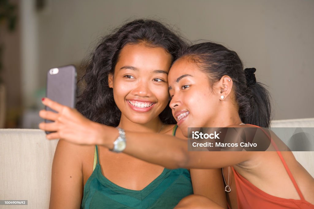 Young Happy And Beautiful Asian Sisters Or Girlfriends Couple Smiling Cheerful Taking Selfie