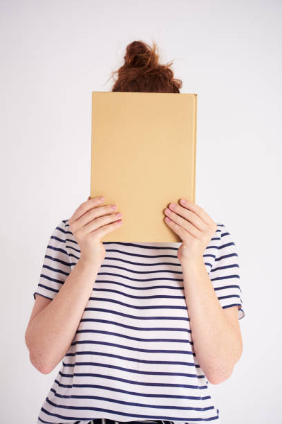 Free Stock Photo of Woman Holding Book Up to Face | Download Free ...