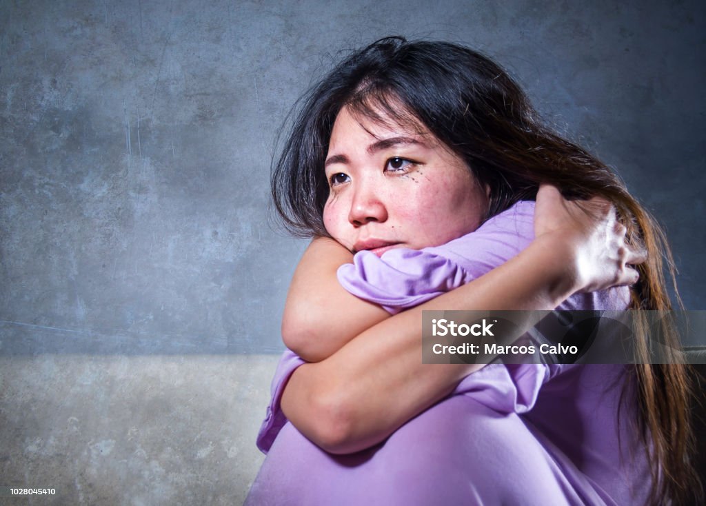Young Sad And Depressed Asian Chinese Woman Crying Alone Desperate