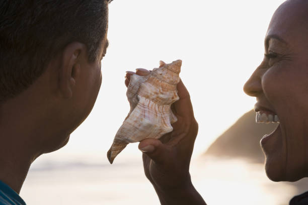Free Stock Photo of Person Holding Seashell in Front of Wave | Download ...