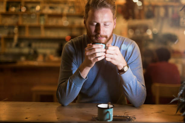 Free Stock Photo of Man lounging with coffee in moody setting ...