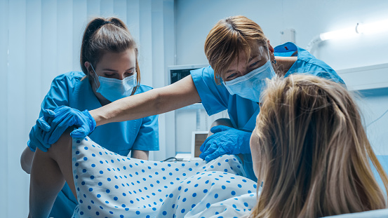 In The Hospital Woman In Labor Pushes To Give Birth Obstetricians