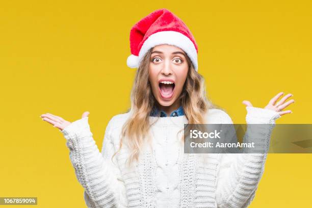 Beautiful Young Blonde Woman Wearing Christmas Hat Over Isolated