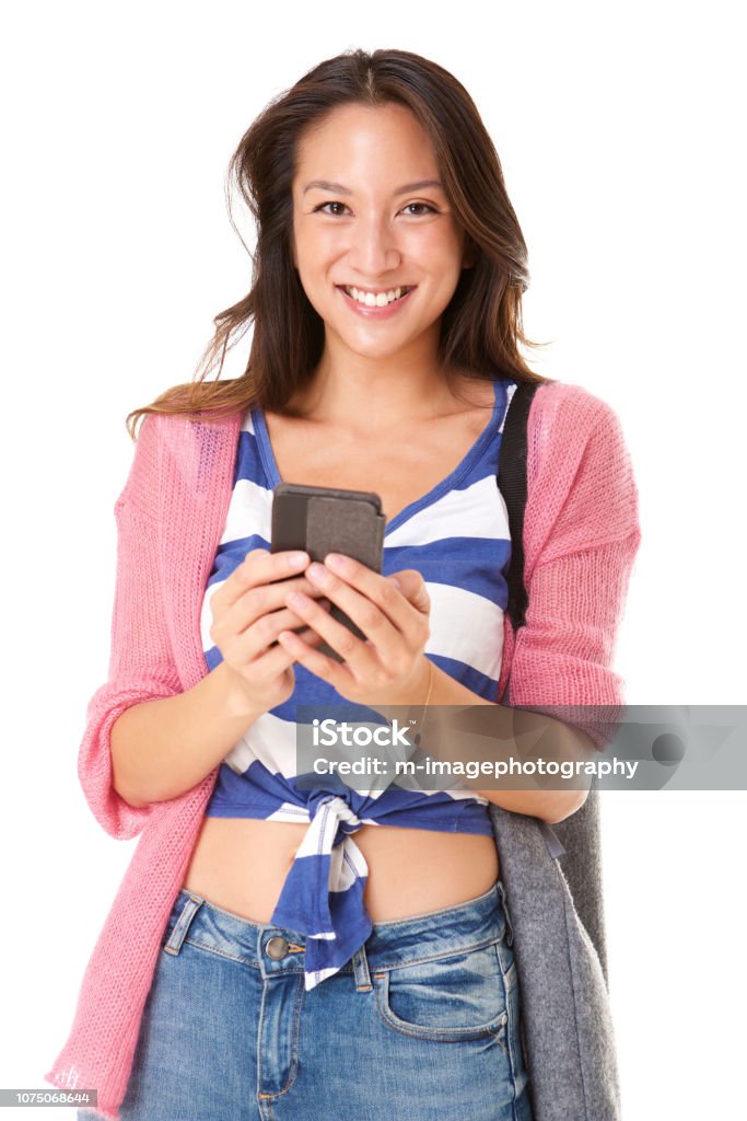 Beautiful Young Asian Woman Holding Mobile Phone And Smiling Against