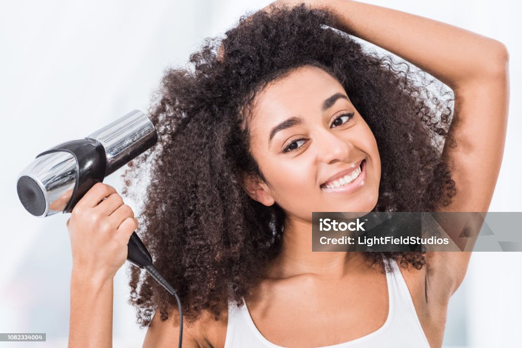 Portrait Of Curly Beautiful African American Girl Drying Hair At Home