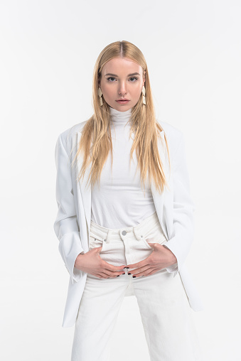 Attractive Caucasian Blonde Woman In Fashionable White Clothes Looking