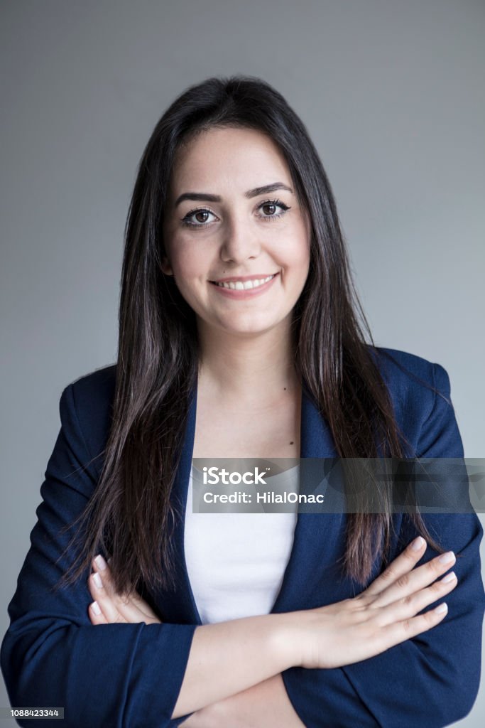 Portrait Of A Standing Young Smiling Confident Business Woman Arms