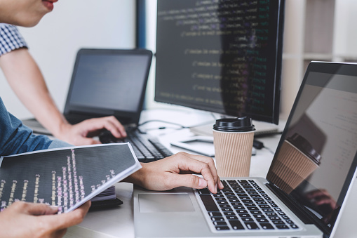 Writing Codes And Typing Data Code Technology Programmer Cooperating Working On Web Site Project