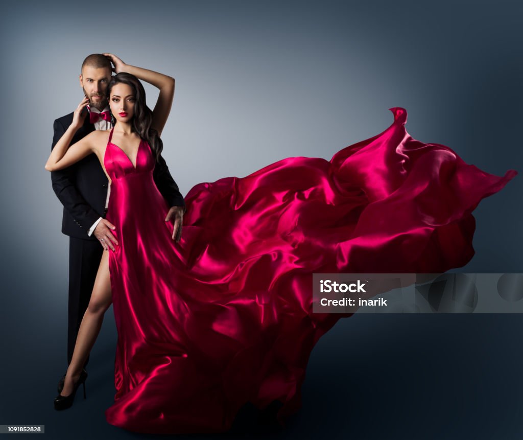 Fashion Couple Young Beautiful Woman In Flying Waving Dress And Elegant