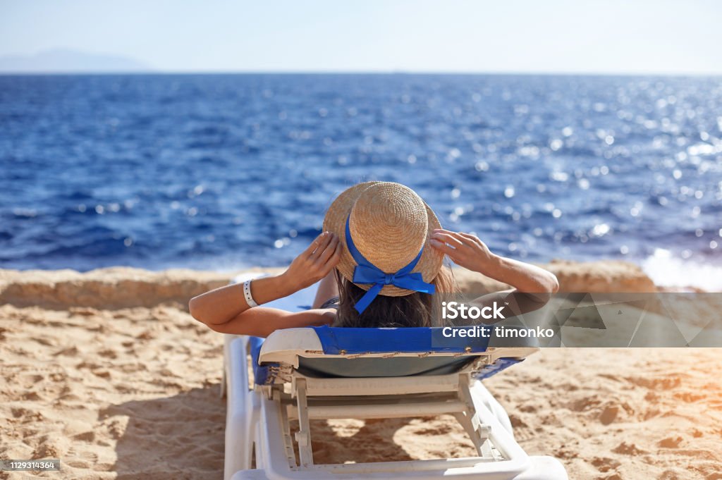 Beautiful Woman Sunbathing On A Beach At Tropical Travel Resort Enjoying Summer Holidays Young