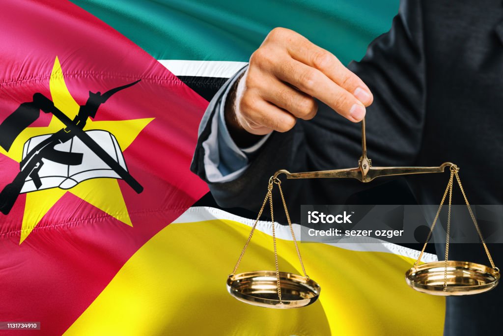 Mozambican Judge Is Holding Golden Scales Of Justice With Mozambique