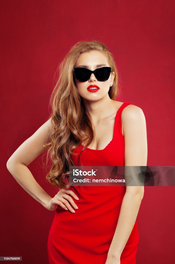 Portrait Of Young Beautiful Fashion Woman Wearing Red Dress And Black