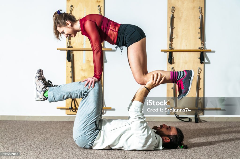 Young Healthy Yoga Fitness Acrobatic Couple Having Fun In The Gym ... Young Healthy Yoga Fitness Acrobatic Couple Having Fun In The Gym ...