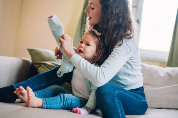Free Stock Photo of Mother dressing her child in the morning | Download ...