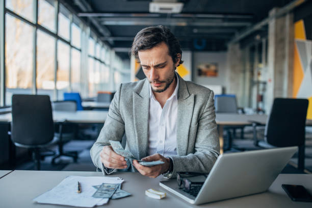 Free Stock Photo of Businessperson counting cash near laptop | Download ...