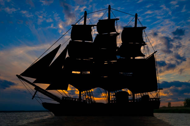 Free picture: Pirate sailing boat in sunset with orange yellow sky
