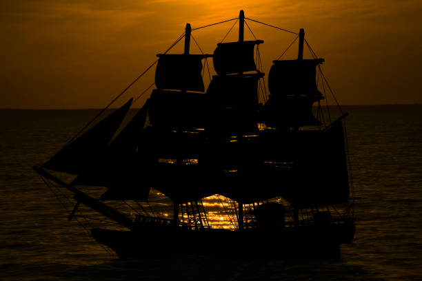 Free picture: Pirate sailing boat in sunset with orange yellow sky