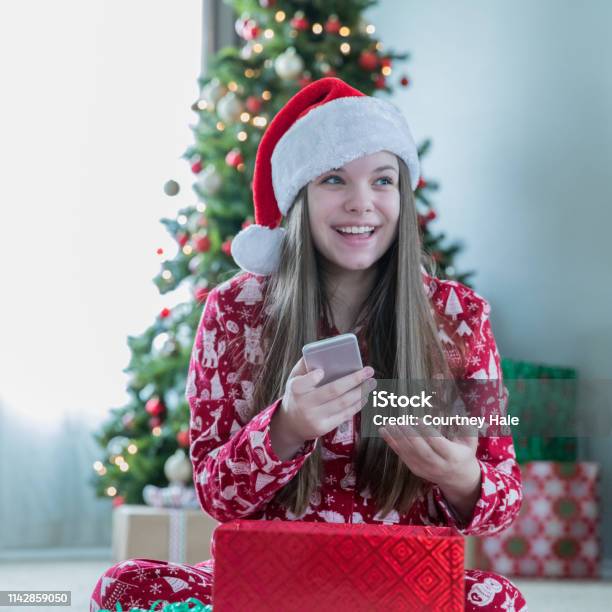 Happy Preteen Girl Receives Smart Phone As T On Christmas Morning