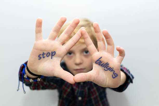 Sad little boy showing his hands with written text Stop bullying, kid ...