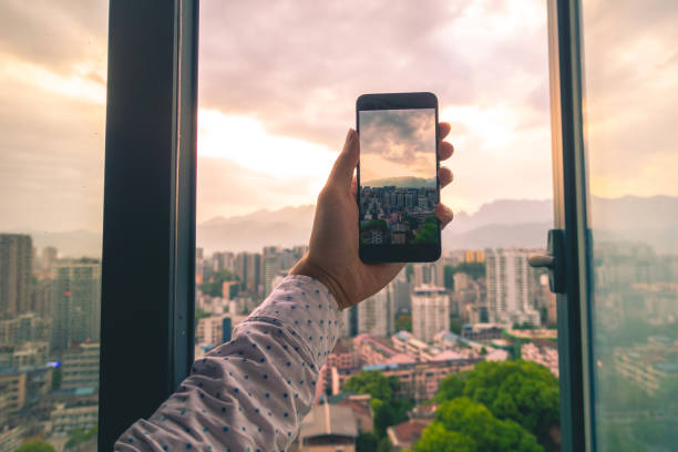 Free Stock Photo of A hand holding a phone taking a picture of a sunset ...