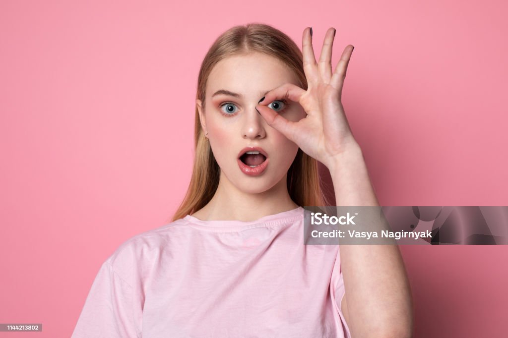 Beautiful Joyful Blonde Girl With Blue Eyes Smiling Demonstrating Open Mouth Looking At The