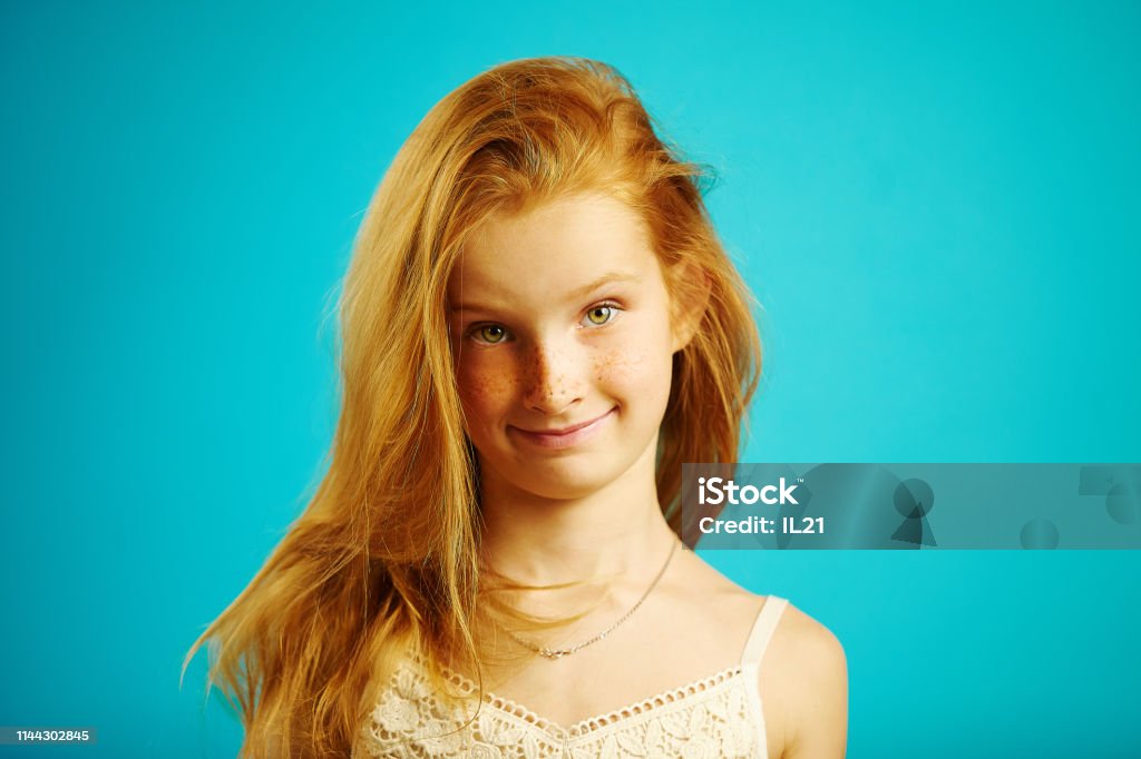 Portrait Of Beautiful Red Haired Girl With Cute Expression Shows