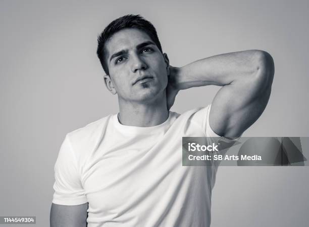 Young Muscular Fitness Man Touching And Grabbing His Neck And Upper ... Young Muscular Fitness Man Touching And Grabbing His Neck And Upper ...