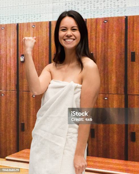 Beautiful Female Standing With A Towel At The Gym Locker Room And Doing