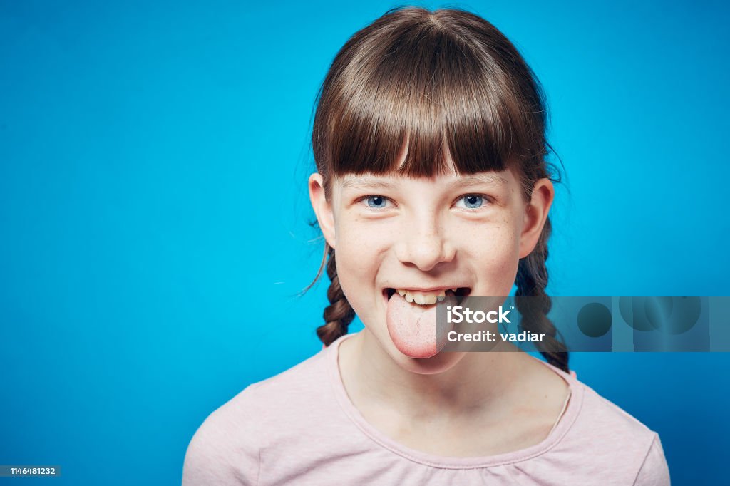 Girl On Yellow Background Sticking Tongue Out Cute Antics And
