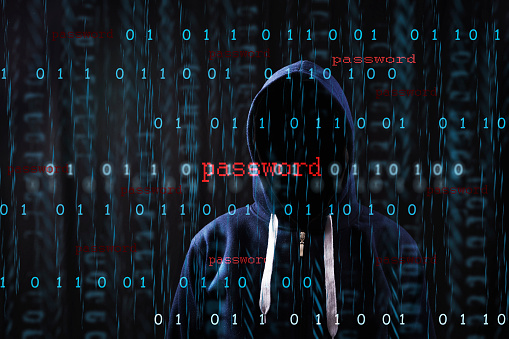 Computer Hacker With A Hood Touches The Touch Screen Binary Code Light
