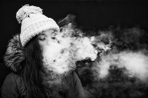 Vape Teenager Young Pretty White Girl Smoking An Electronic Cigarette Opposite Modern Background
