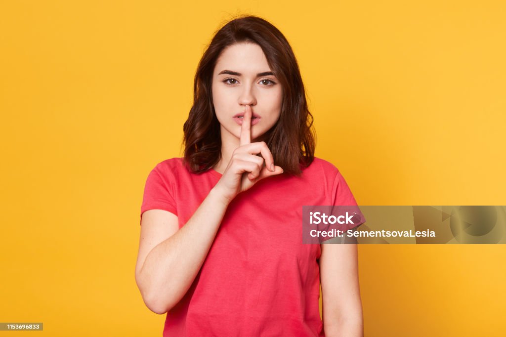 Closeup Portrait Of Secretive Young Woman Keeps Finger On Lips Asking