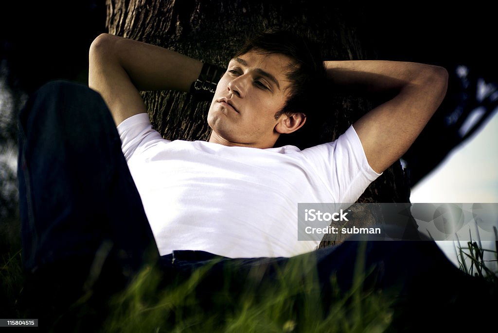 Young Man Relaxing Under Tree Stock Photo - Download Image Now - 18-19 ... Young Man Relaxing Under Tree Stock Photo - Download Image Now - 18-19 ...