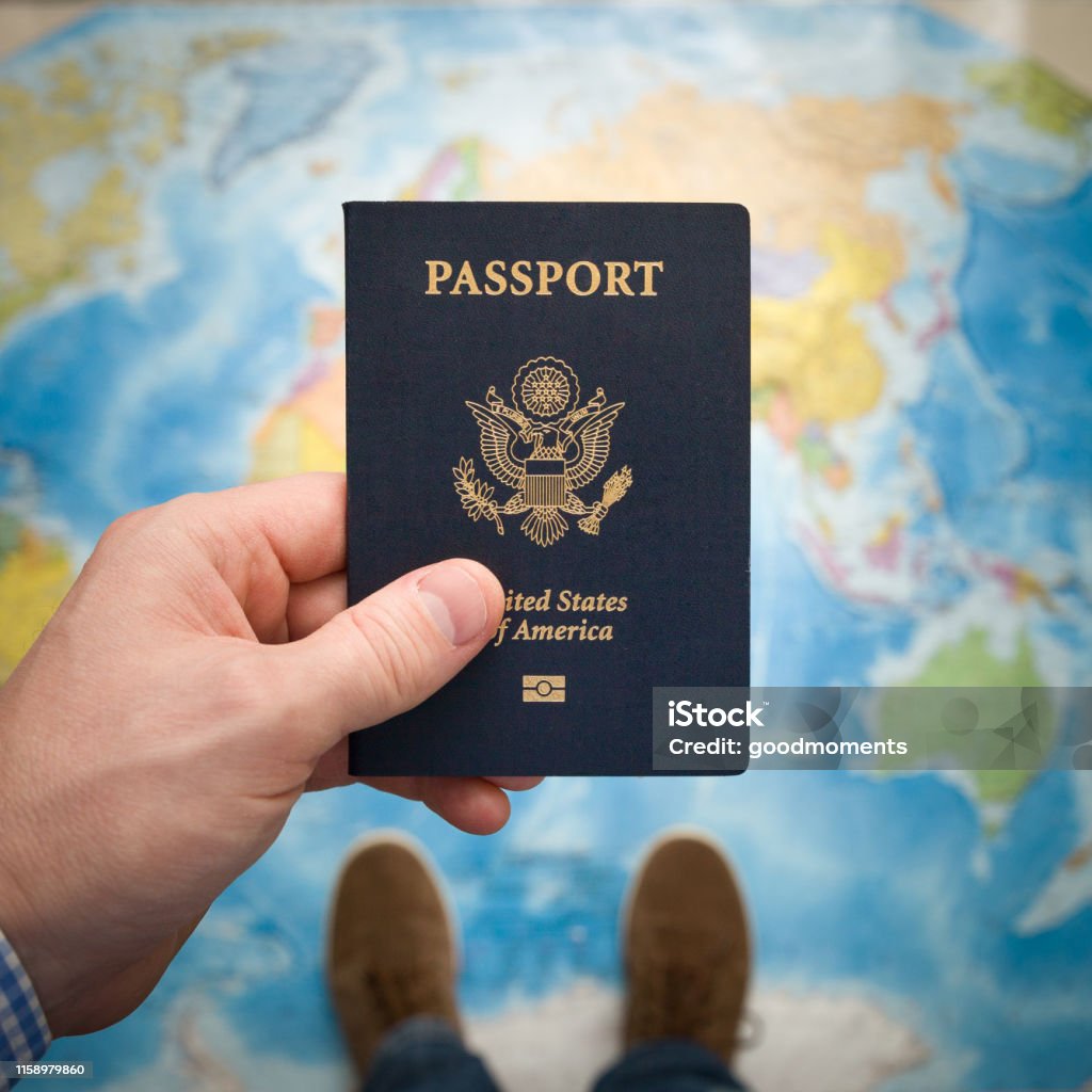 Mans Hand Holding Us Passport Map Background Ready For Traveling Open