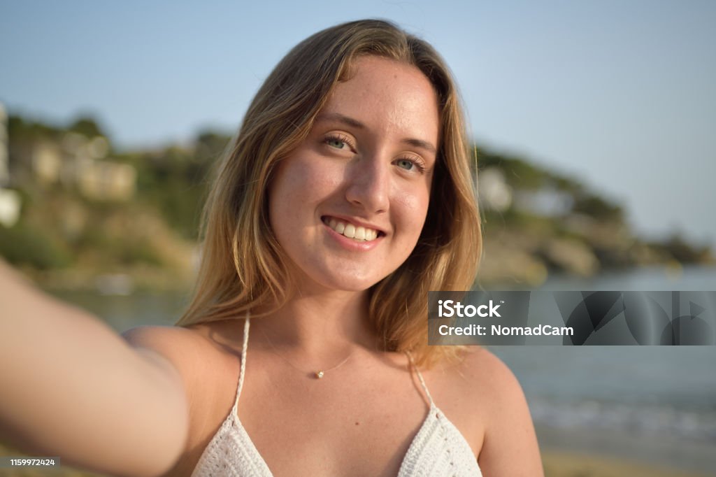 Close Up Portrait Of A Beautiful Girl Smiling And Taking Selfie On The