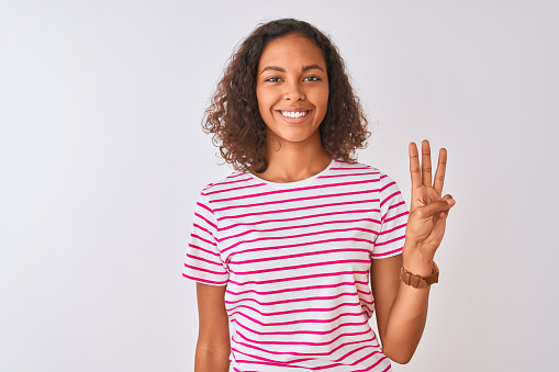 Young Brazilian Woman Wearing Pink Striped Tshirt Standing Over