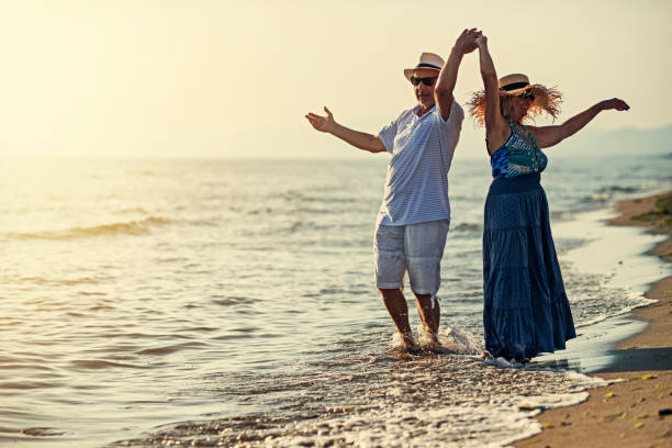 Free Stock Photo of Senior couple holding hands together and dancing at ...
