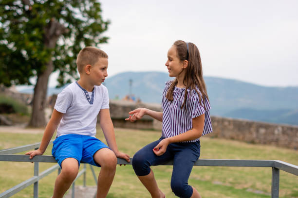 Free Stock Photo of A boy and a girl talking intimately on the pier ...