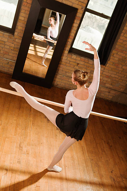 140 Beautiful Young Ballerina Stretching On Wooden Floor Workout Stock