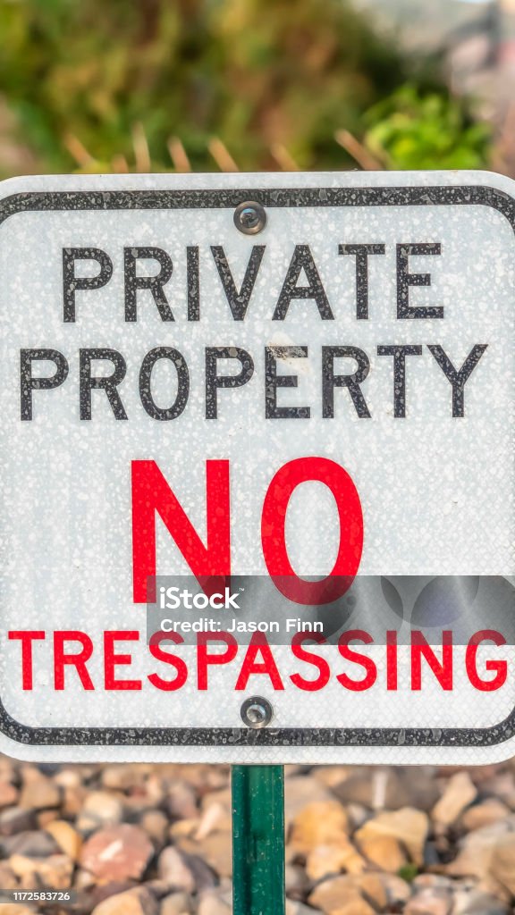 Vertical Frame Private Property No Trespassing Sign With Rocky Terrain