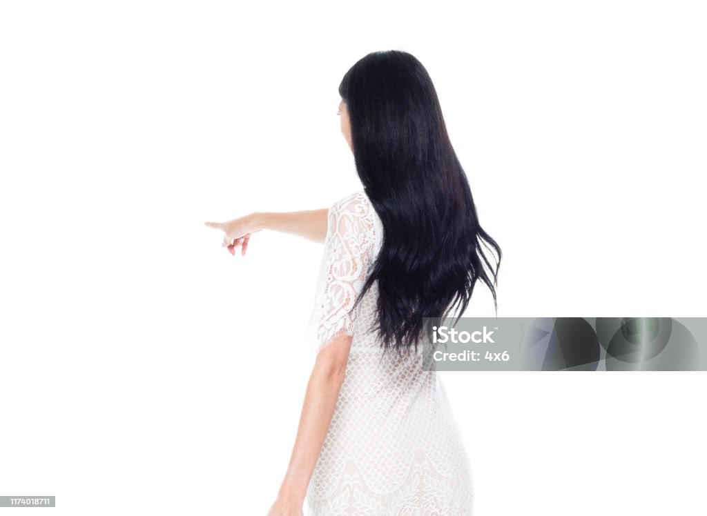 Beautiful Female With Long Hair Wearing White Dress Pointing Stock