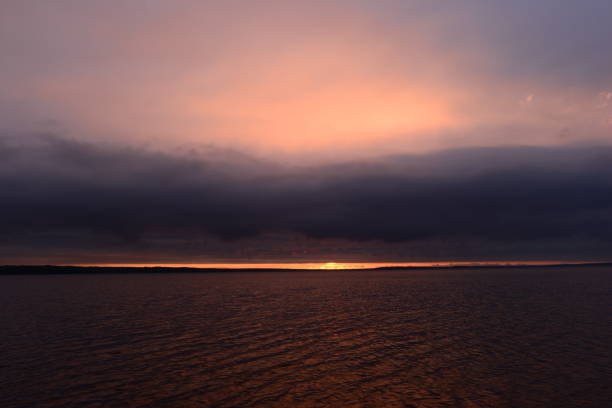 Free Stock Photo of Cloudy Sunset Over a Body of Water | Download Free ...