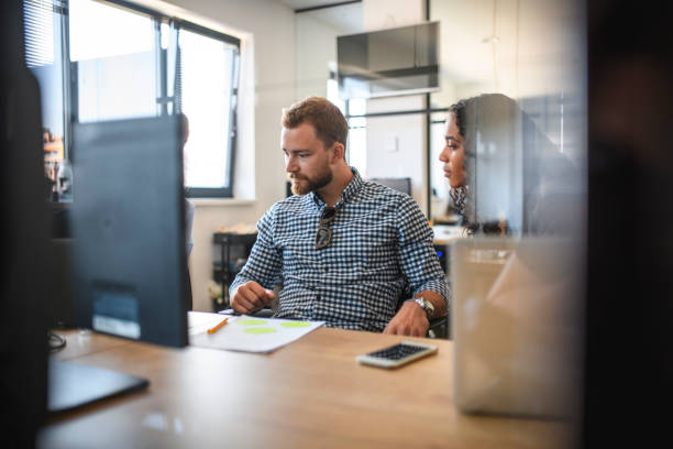 Free Stock Photo of Two colleagues in the office at shared work table ...
