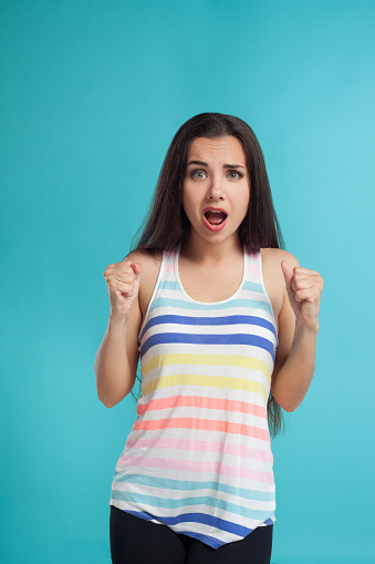 Brunette Woman With Long Hair Dressed In Striped Shirt And Black