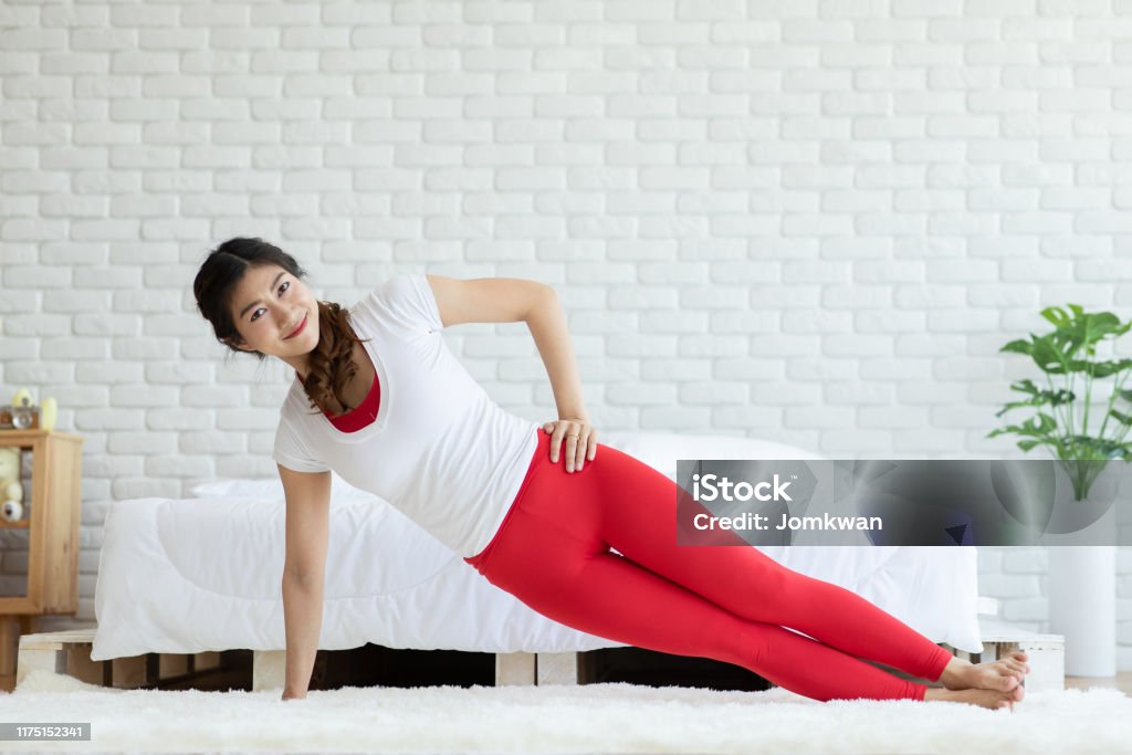 Attractive Asian Woman Practice Yoga Side Plank Pose To Meditation In