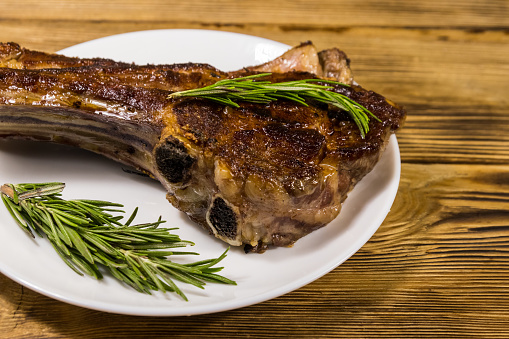 Steak Mata Iga Sapi Panggang Di Tulang Dengan Rosemary Di Piring Putih