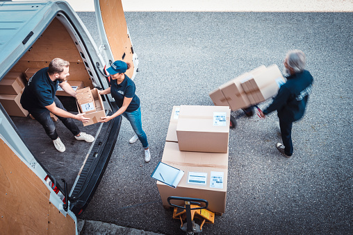 Coworkers Rushing To Load Packages In A Delivery Van Stock Photo ... Coworkers Rushing To Load Packages In A Delivery Van Stock Photo ...