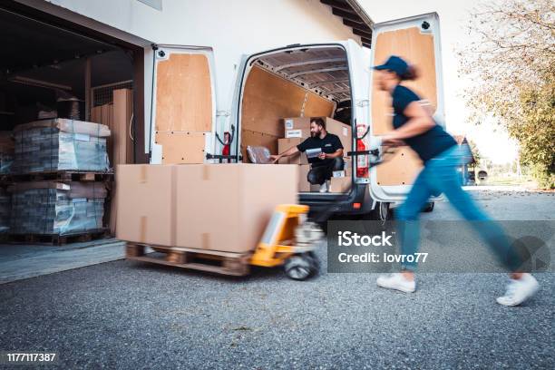 Coworkers Rushing To Load Packages In A Delivery Van Stock Photo ... Coworkers Rushing To Load Packages In A Delivery Van Stock Photo ...